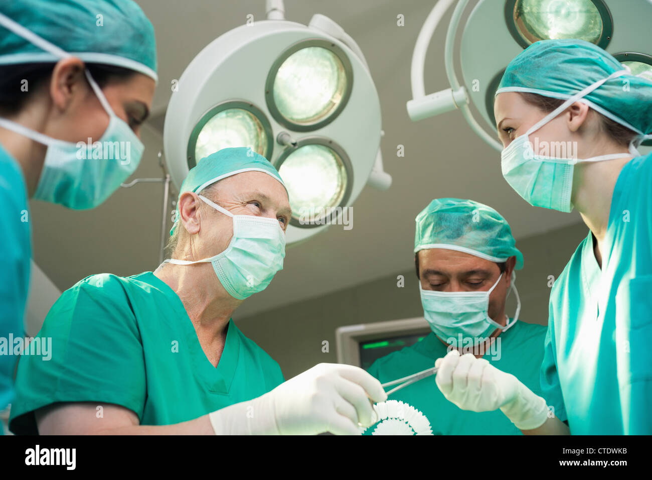 Surgeon team working together Stock Photo - Alamy