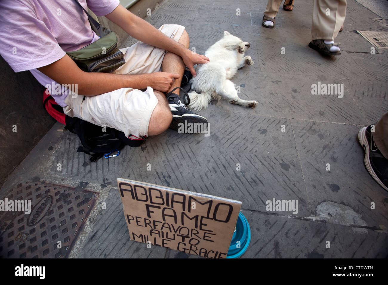 Beggar with dog in street in central Florence, Italy - sign says hungry ...