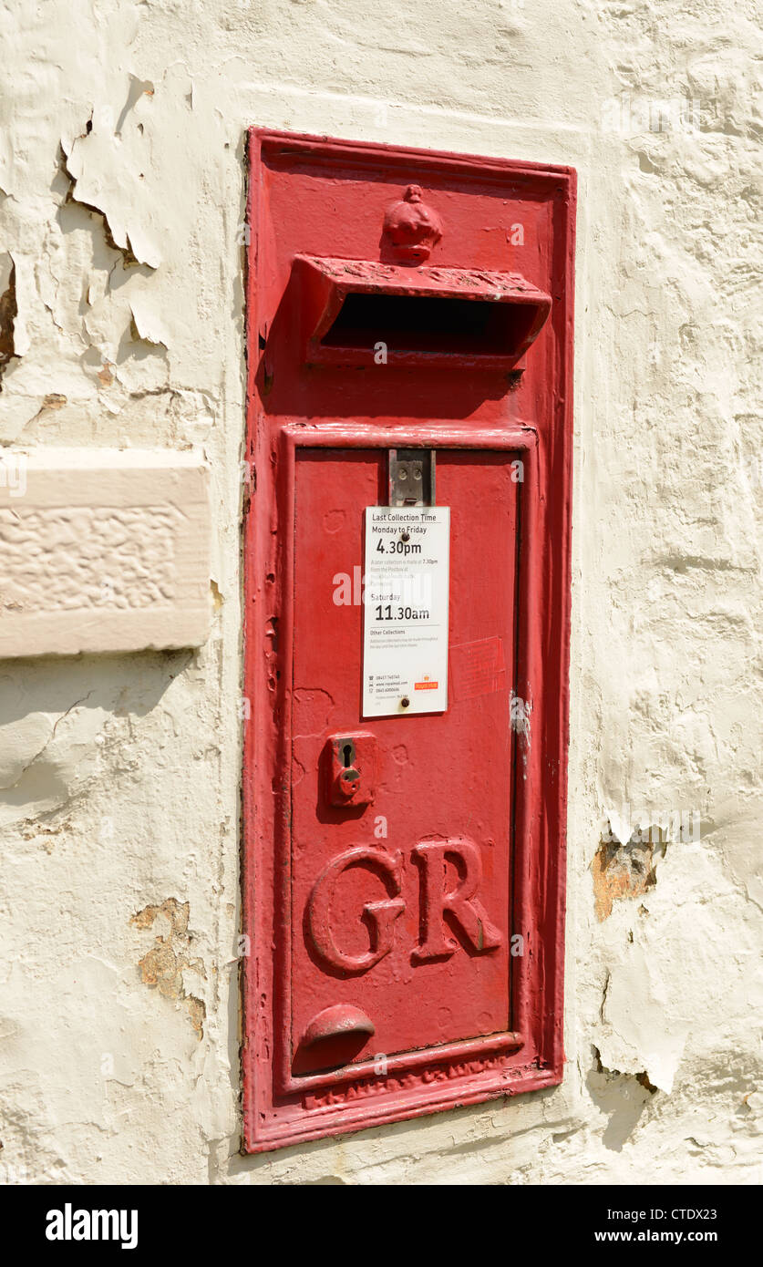 Red post box inset into a brick wall Stock Photo - Alamy