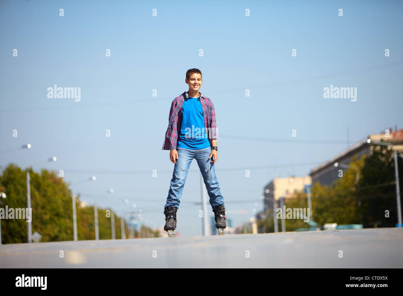 Handsome young man skating in urban surroundings Stock Photo - Alamy