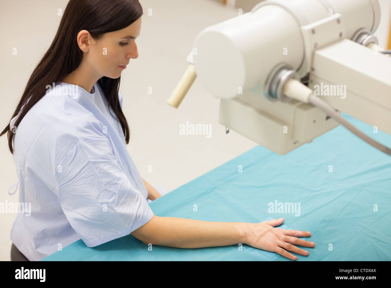Patient placing her hand on a medical table Stock Photo - Alamy