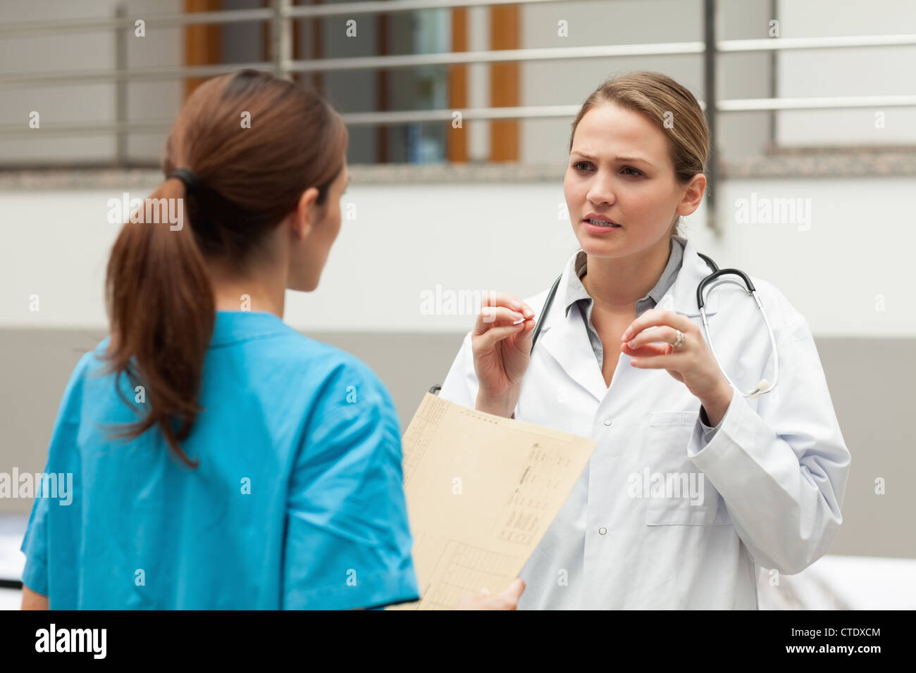 Doctor explaining something to someone Stock Photo - Alamy