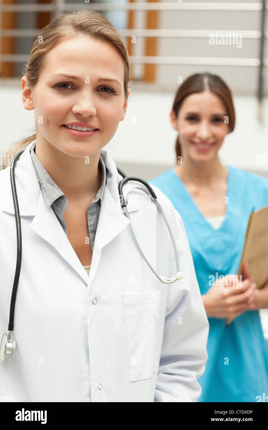 Doctor standing in a hospital reception with a nurse Stock Photo - Alamy