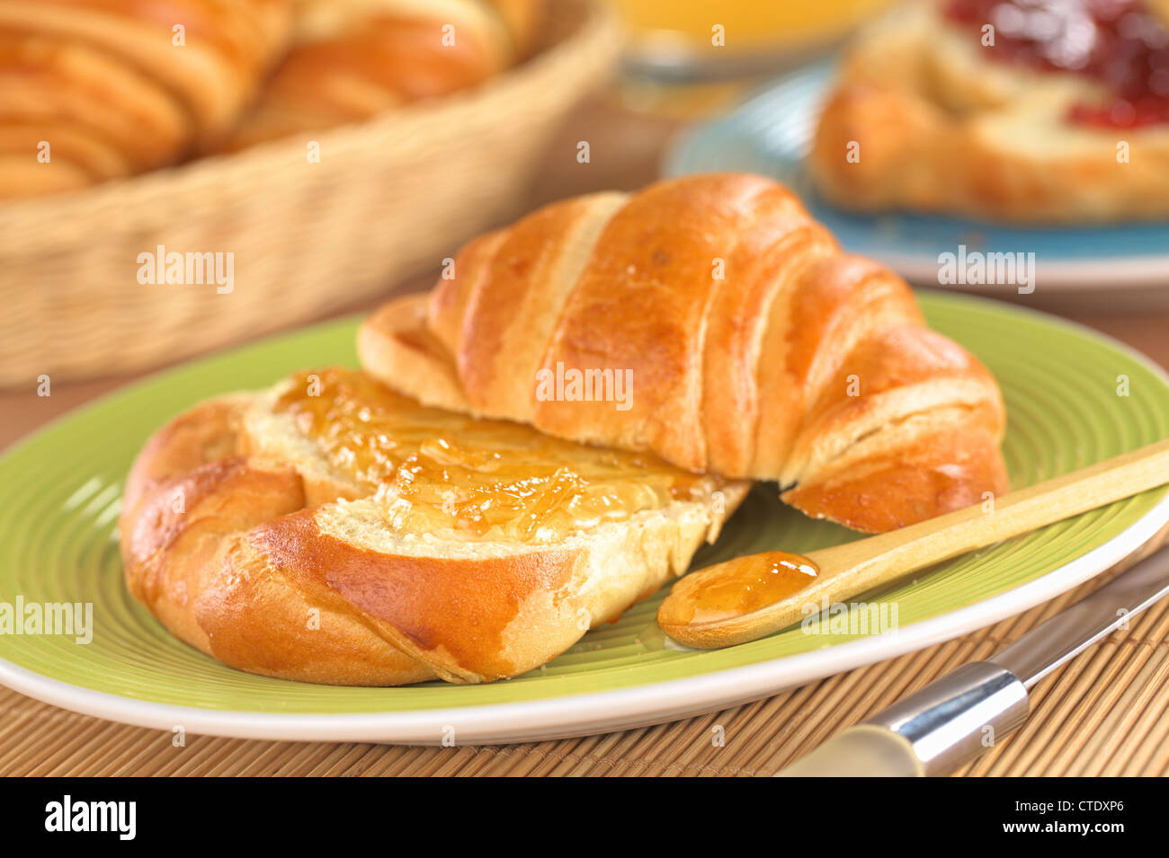 Croissant with butter and orange jam Stock Photo - Alamy