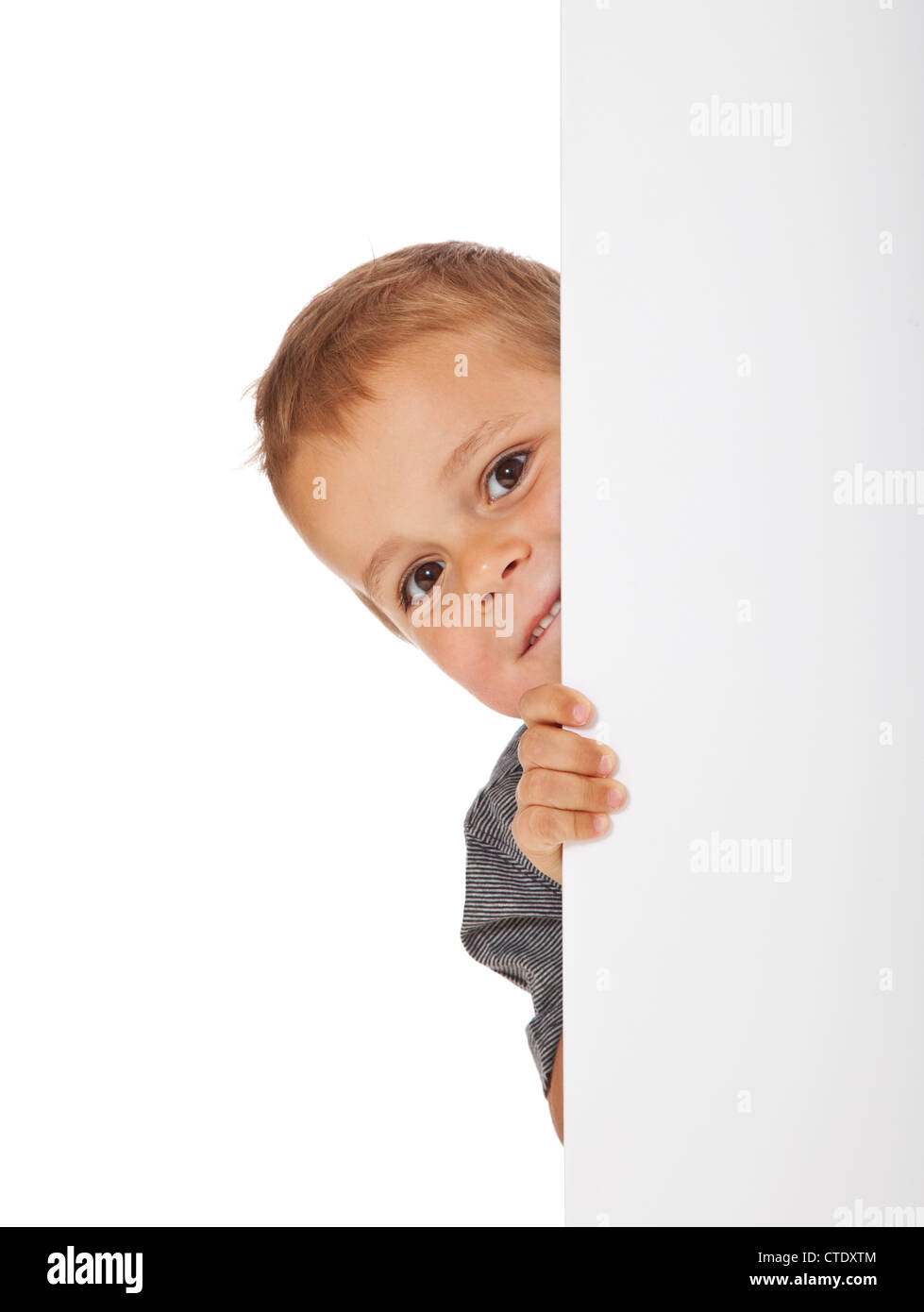 Cute little boy hiding behind a white wall. All isolated on white ...