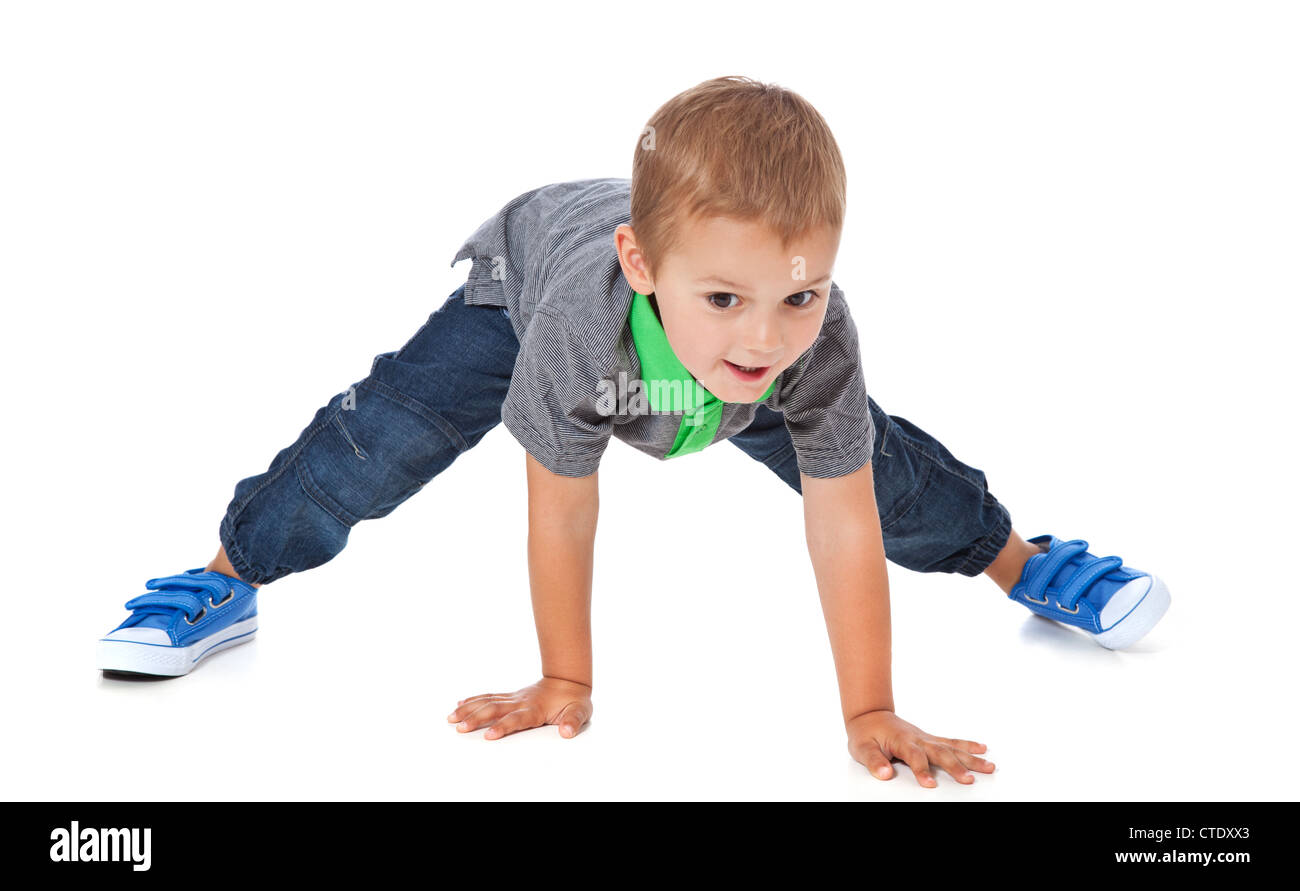 Full length shot of a cute little boy doing sports. All isolated on ...