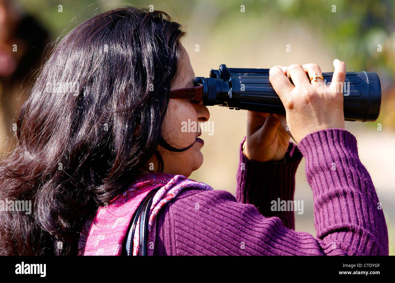 Young explorer looking through binoculars Stock Photo - Alamy