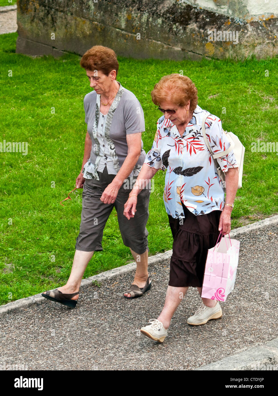 Overhead view of two women walking along pavement - France Stock Photo ...