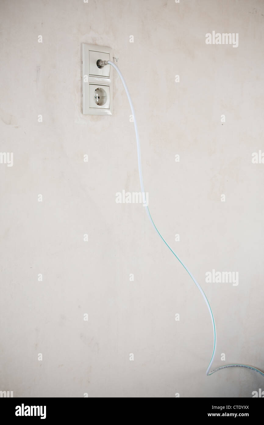 Interior wall with domestic power and tv outlet Stock Photo - Alamy