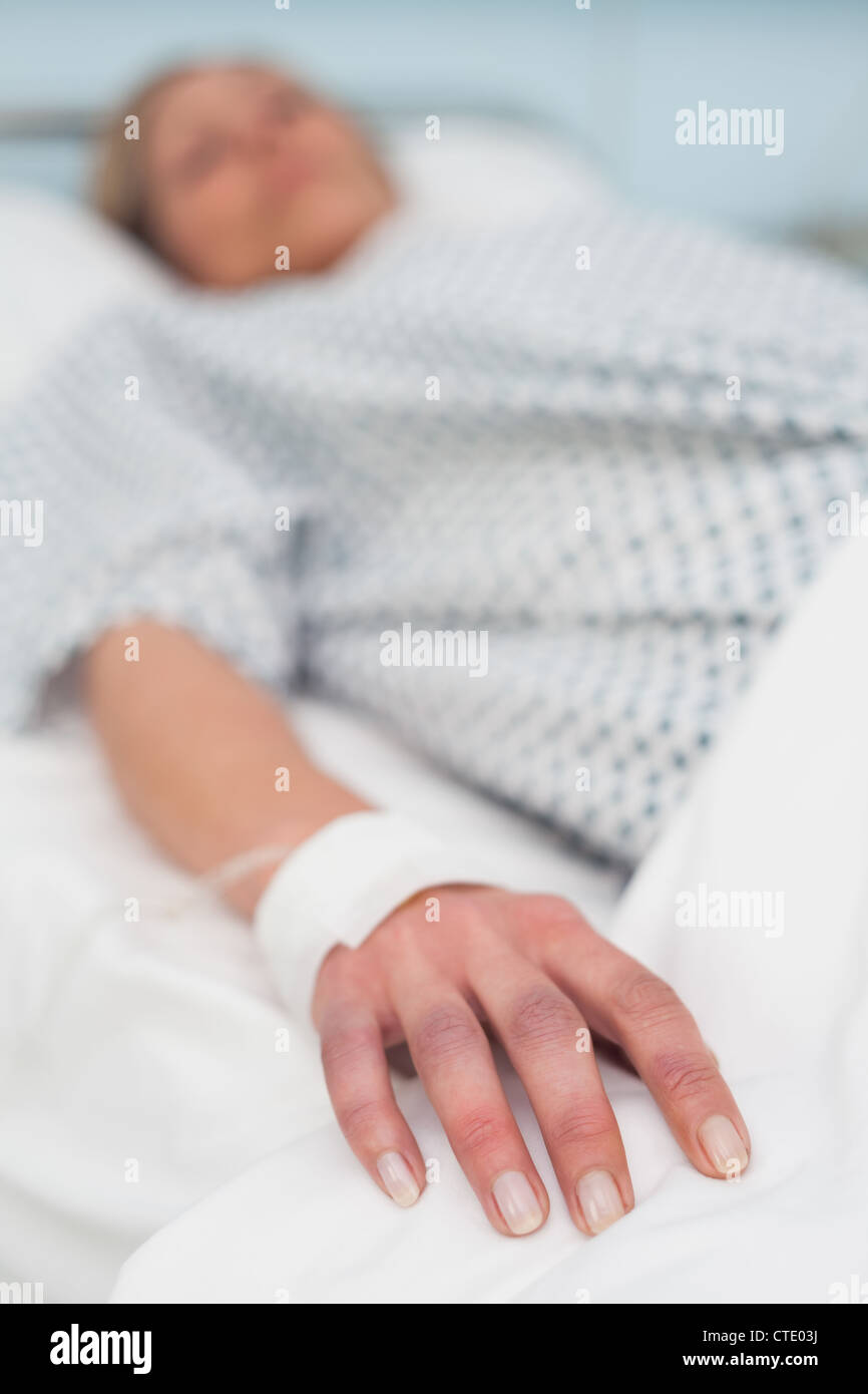 Focus on the hand of a patient lied on a bed Stock Photo - Alamy