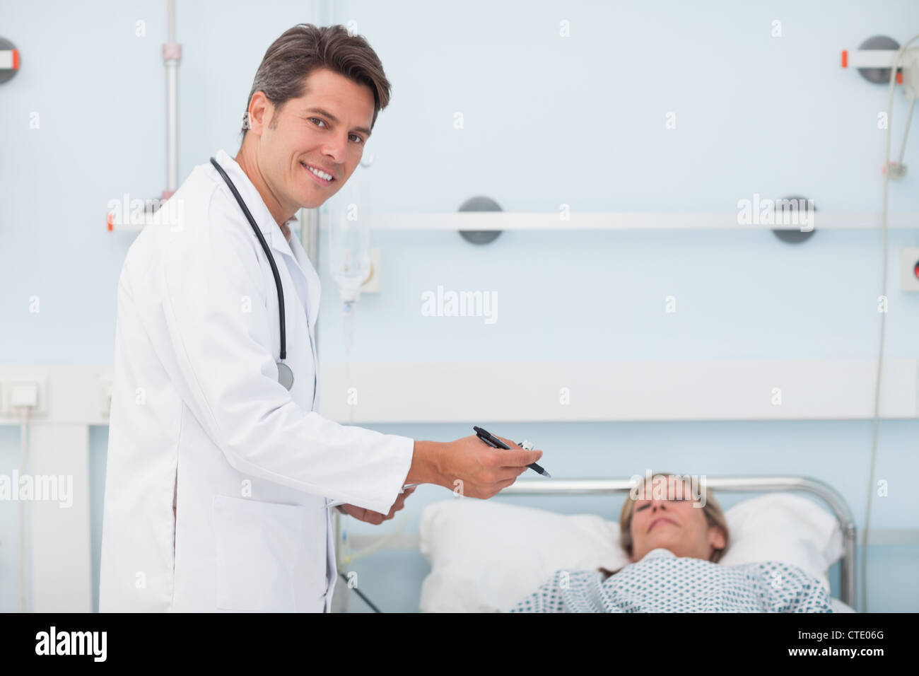 Doctor standing next to his patient Stock Photo - Alamy