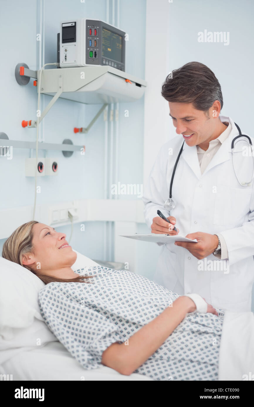 Doctor standing while holding a chart Stock Photo - Alamy