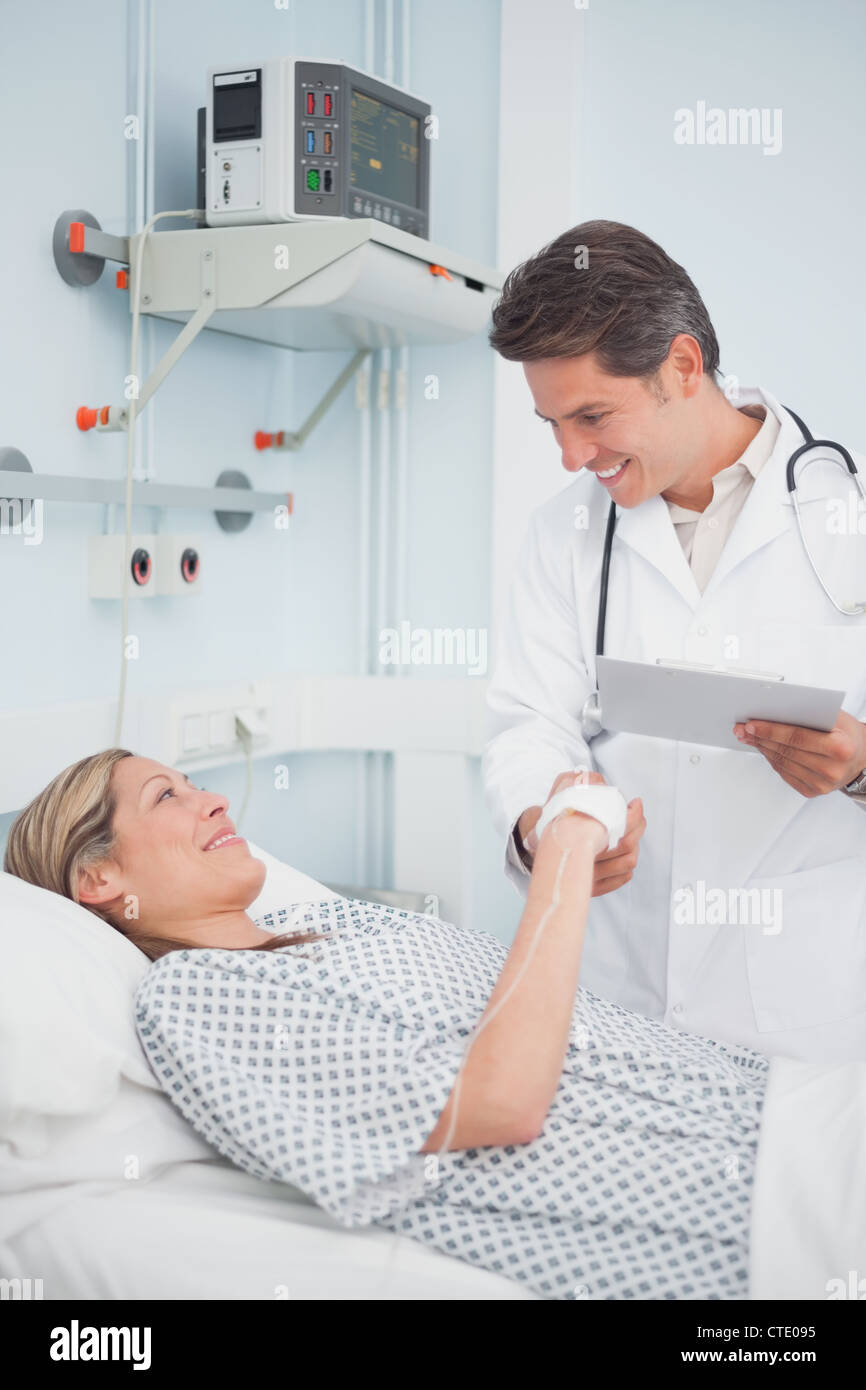 Doctor smiling to his patient Stock Photo - Alamy