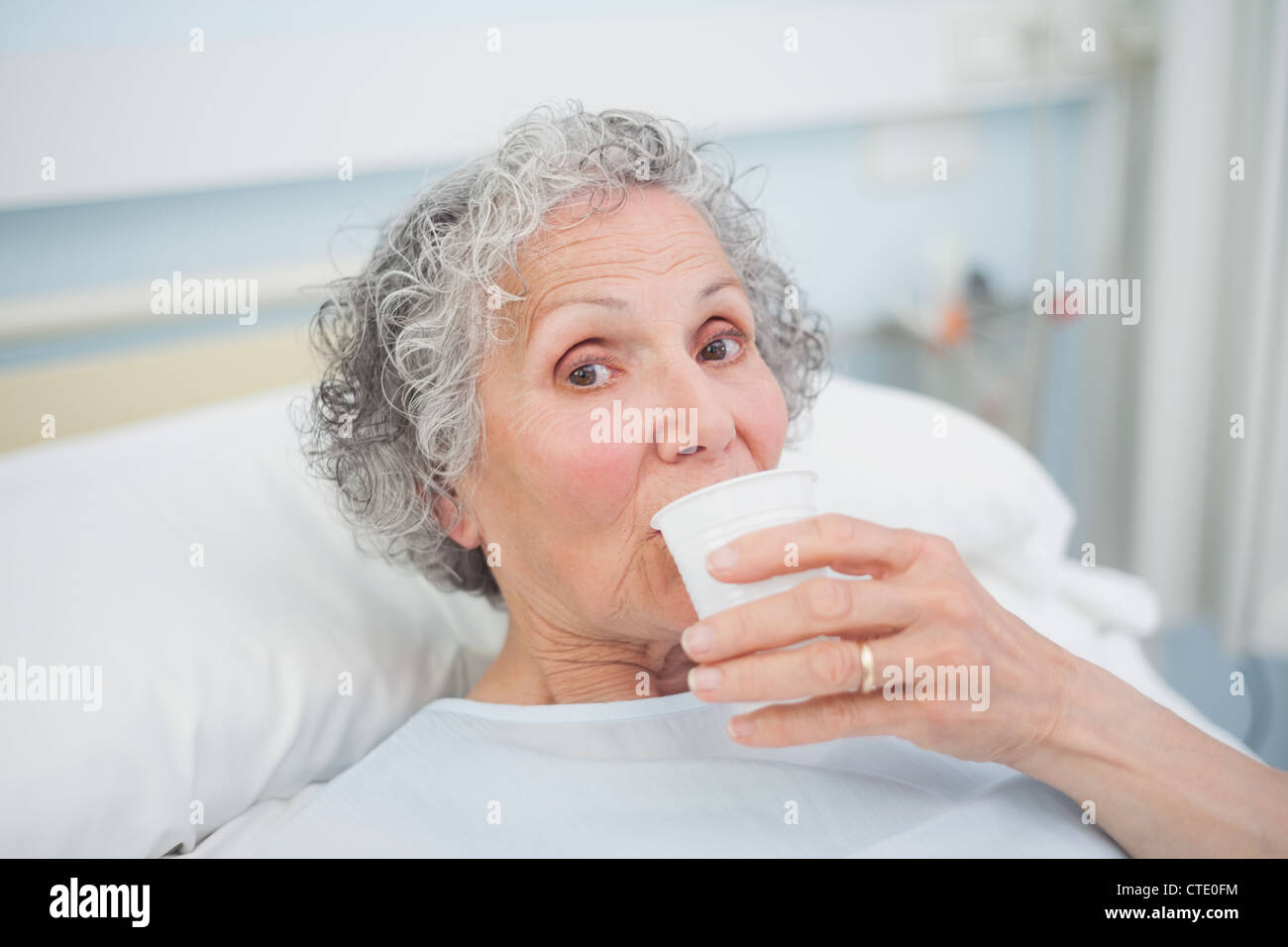 Elderly patient drinking Stock Photo - Alamy