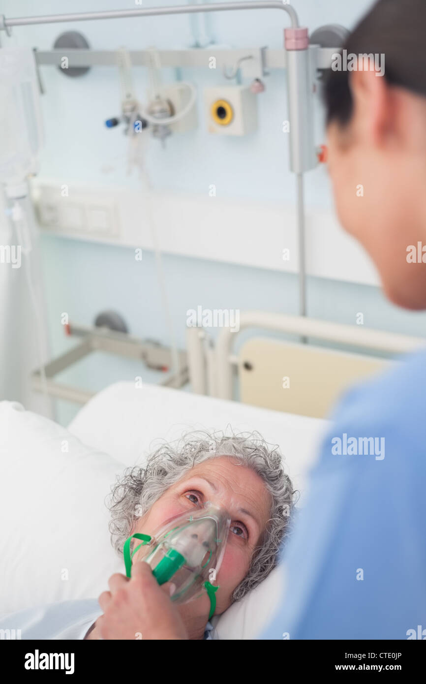 Patient having an oxygen mask on her face Stock Photo - Alamy