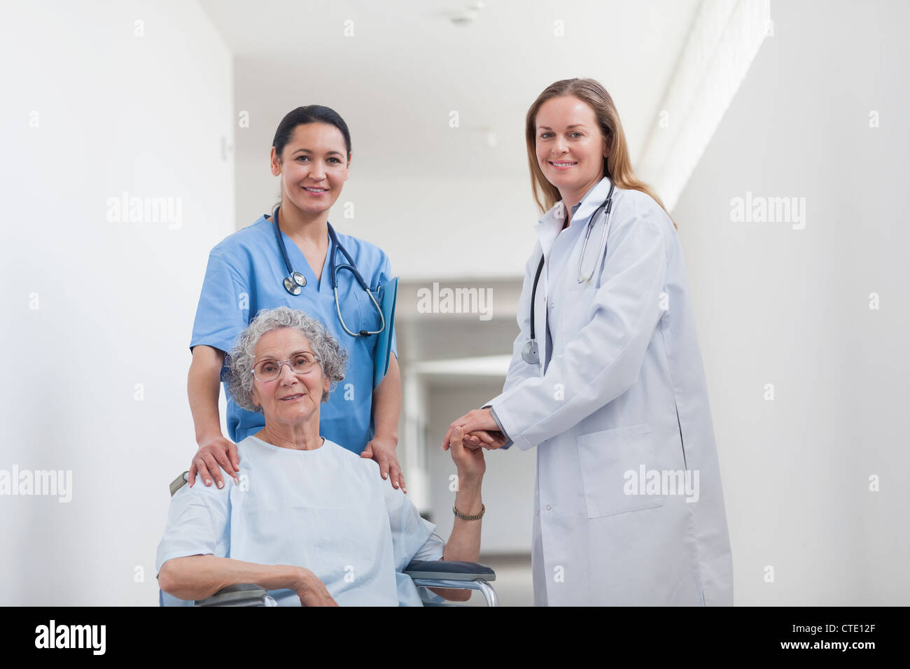 Patient in corridor holding hand of a doctor Stock Photo - Alamy