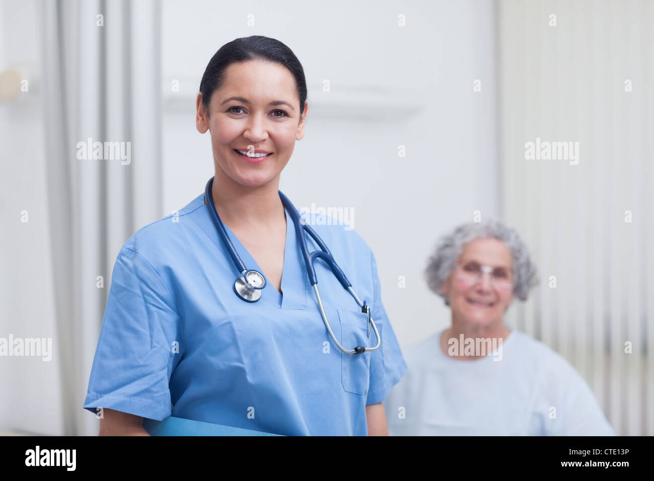 Nurse and a patient looking at camera Stock Photo - Alamy