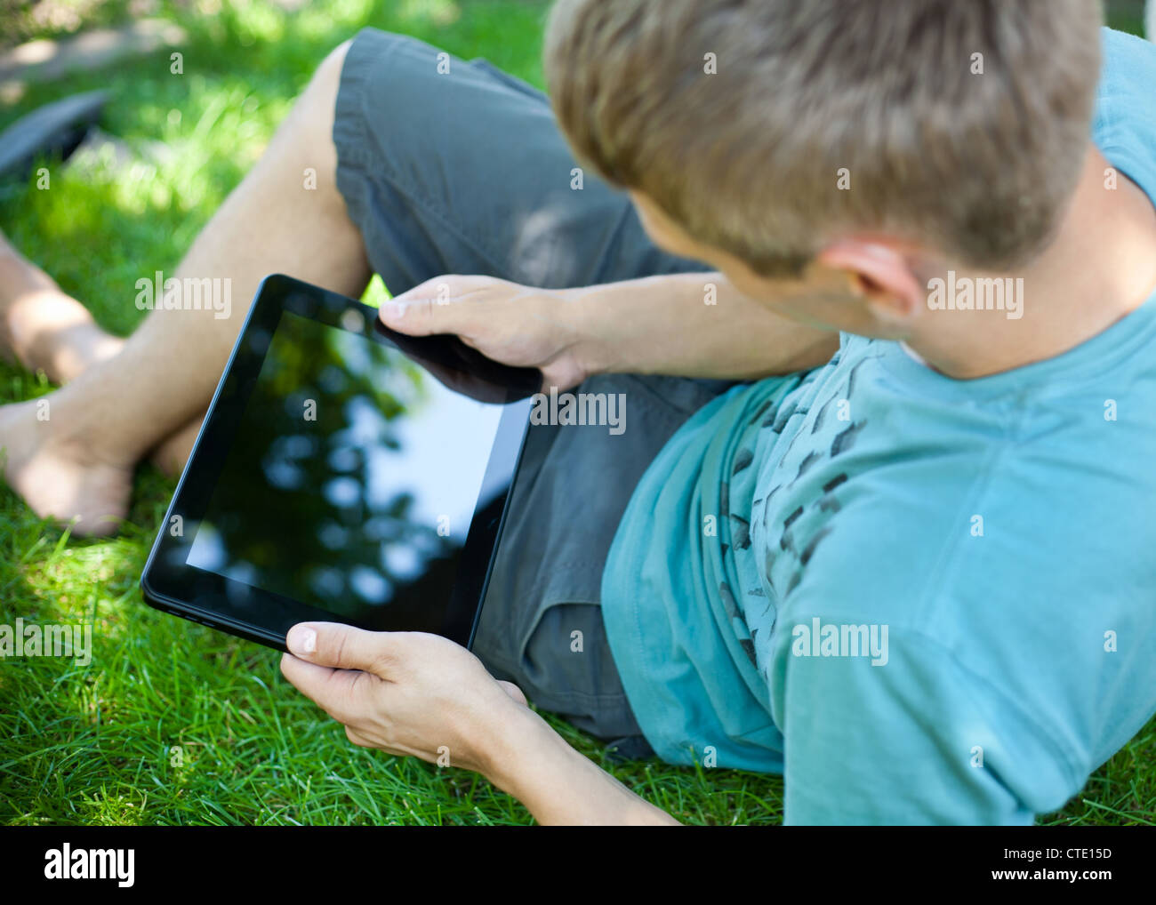 Man uses tablet outdoor close hi-res stock photography and images - Alamy