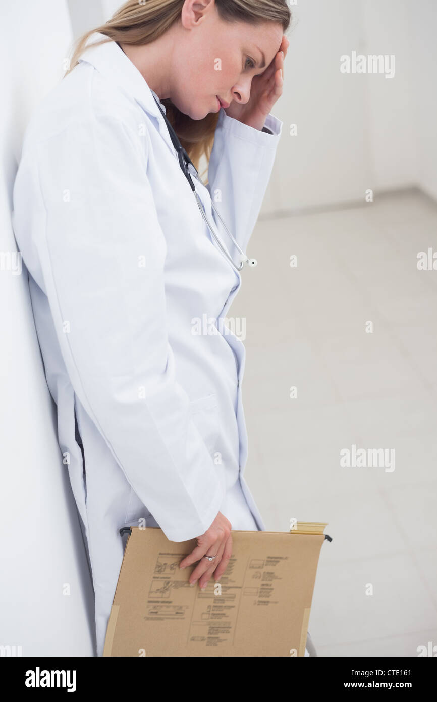 Doctor touching her forehead Stock Photo - Alamy Doctor touching her forehead Stock Photo - Alamy