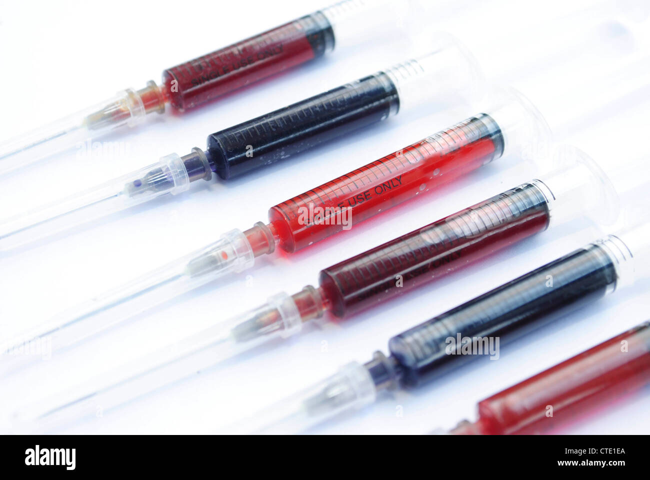 Medical syringes with colorful liquid isolated over white Stock Photo ...