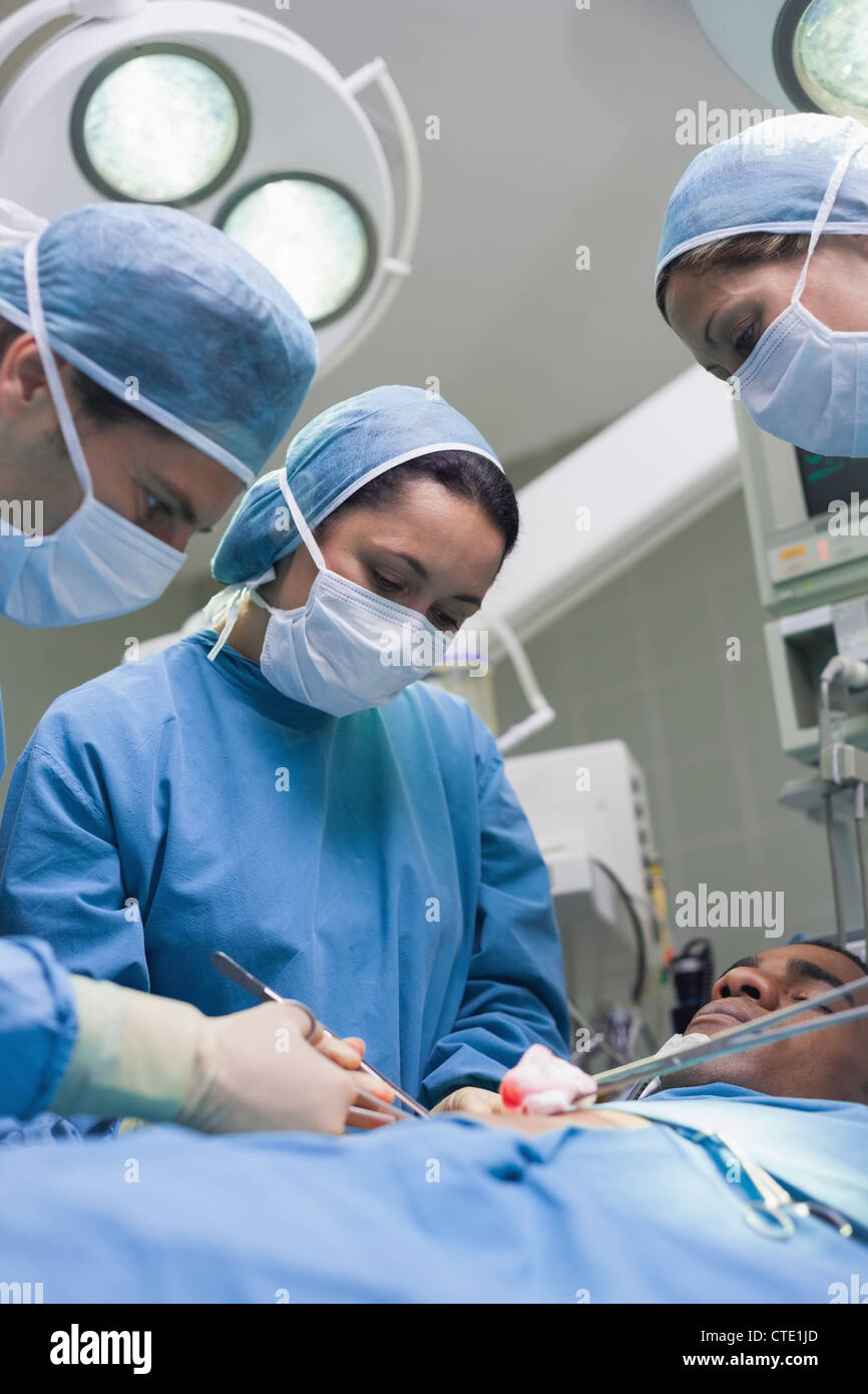 Doctors operating with surgical tools Stock Photo - Alamy