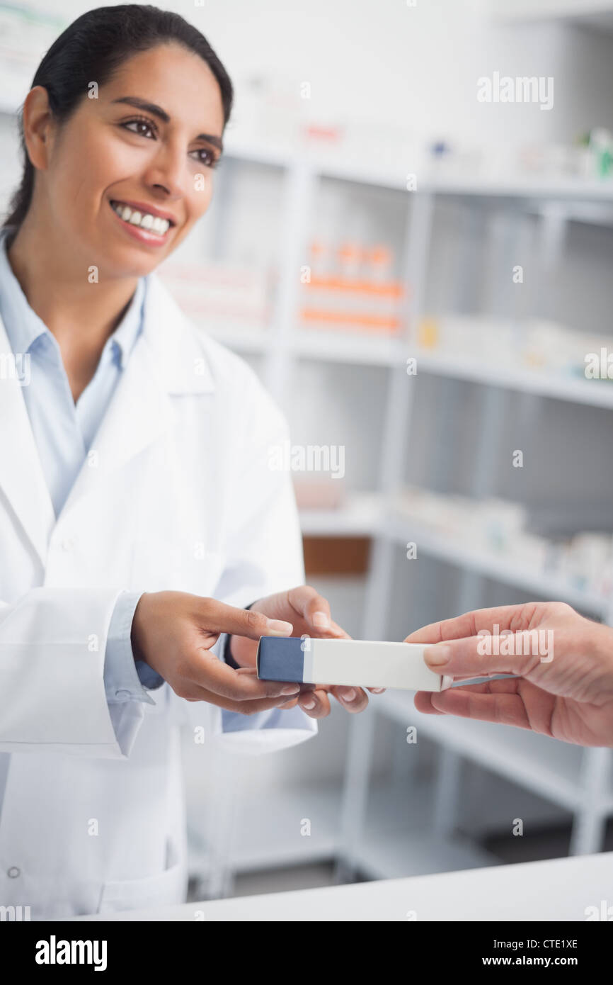 Pharmacist giving a drug box to someone Stock Photo - Alamy