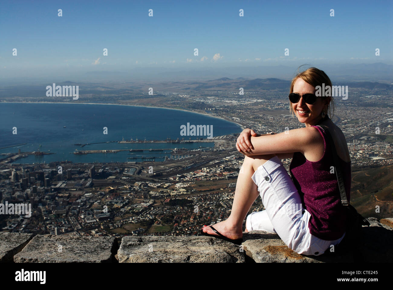 A girl woman looks out over Cape Town and Table Bay from Table Mountain ...