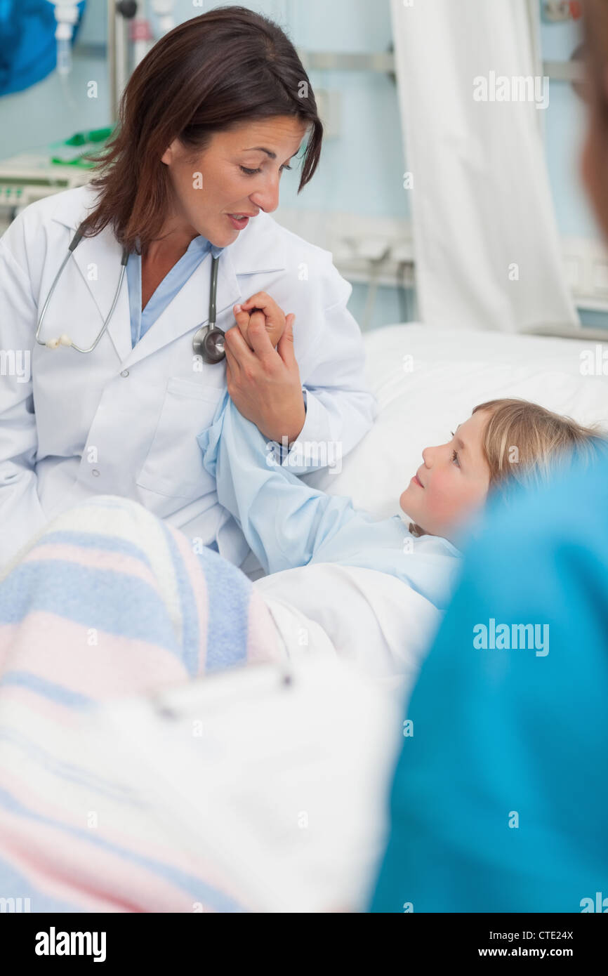 Doctor sitting next to a child Stock Photo - Alamy