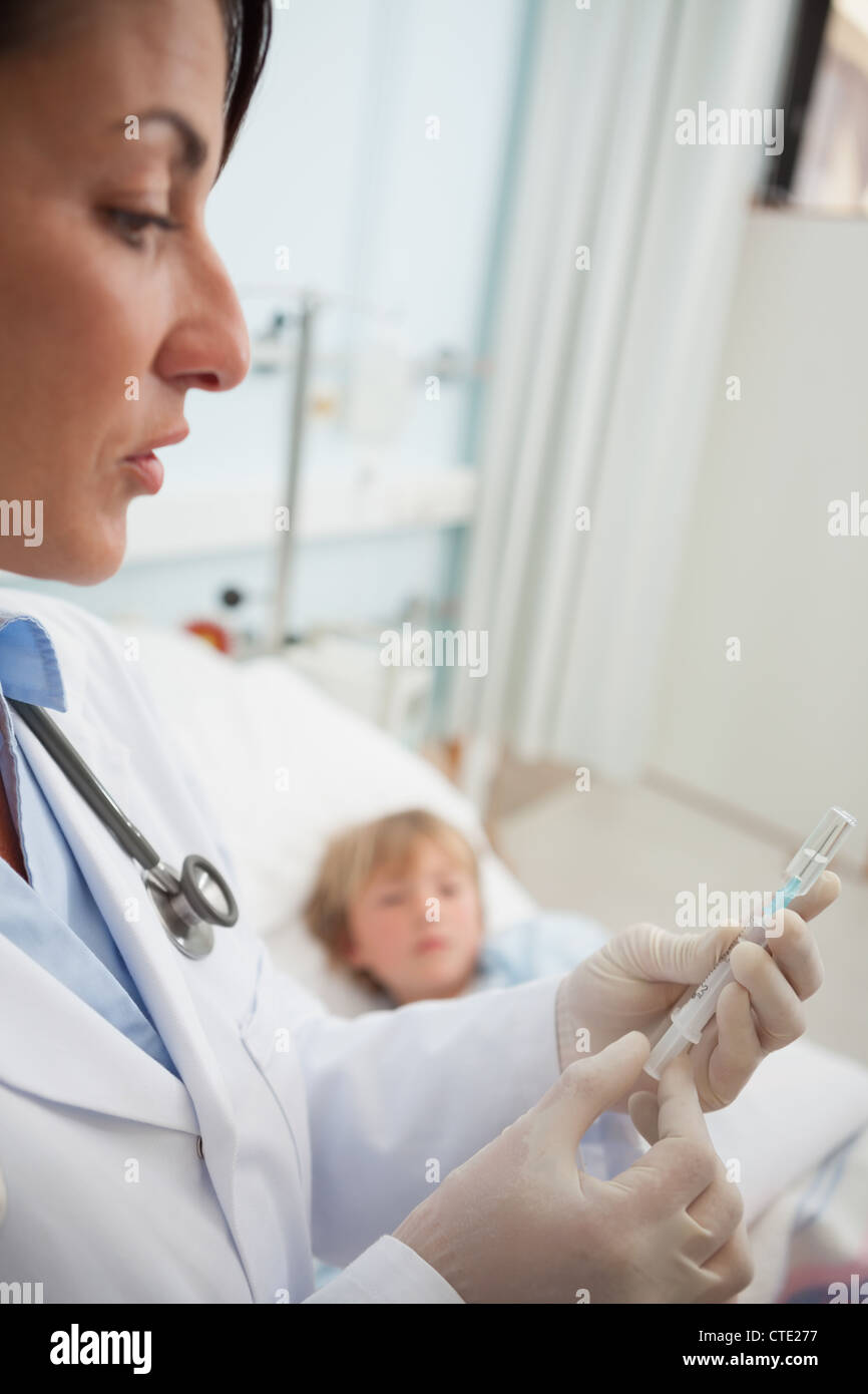 Doctor measuring a syringe Stock Photo - Alamy