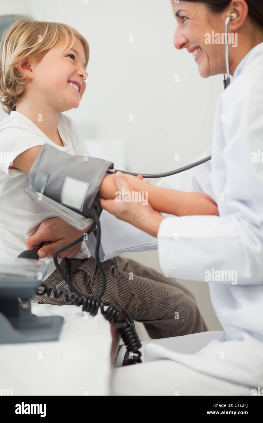 Doctor examining blood pressure of a child Stock Photo - Alamy