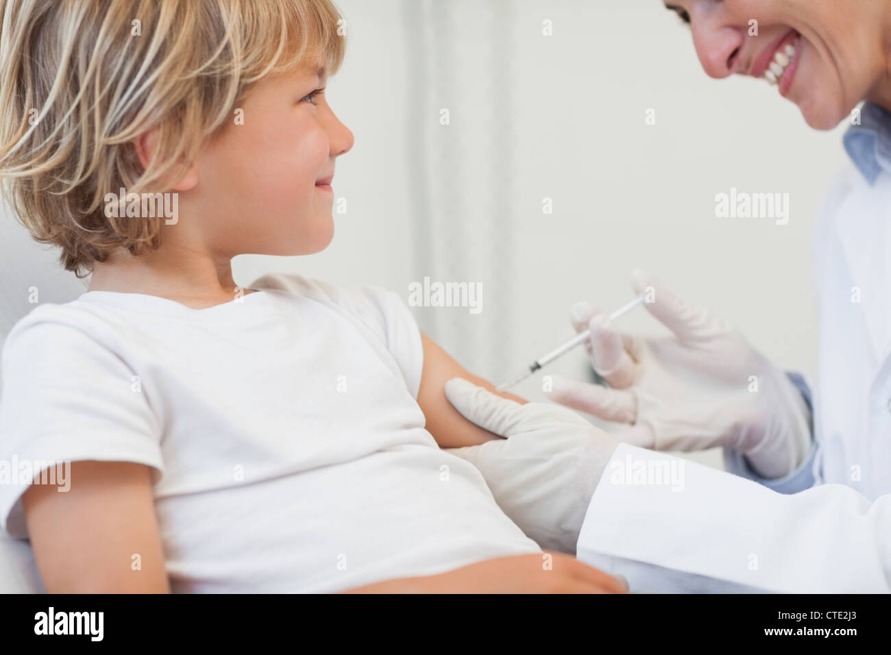 Doctor giving to a child an injection Stock Photo - Alamy