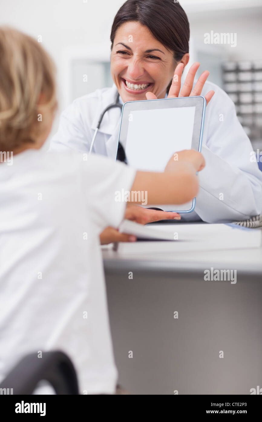 Child touching the tablet computer of a doctor Stock Photo - Alamy