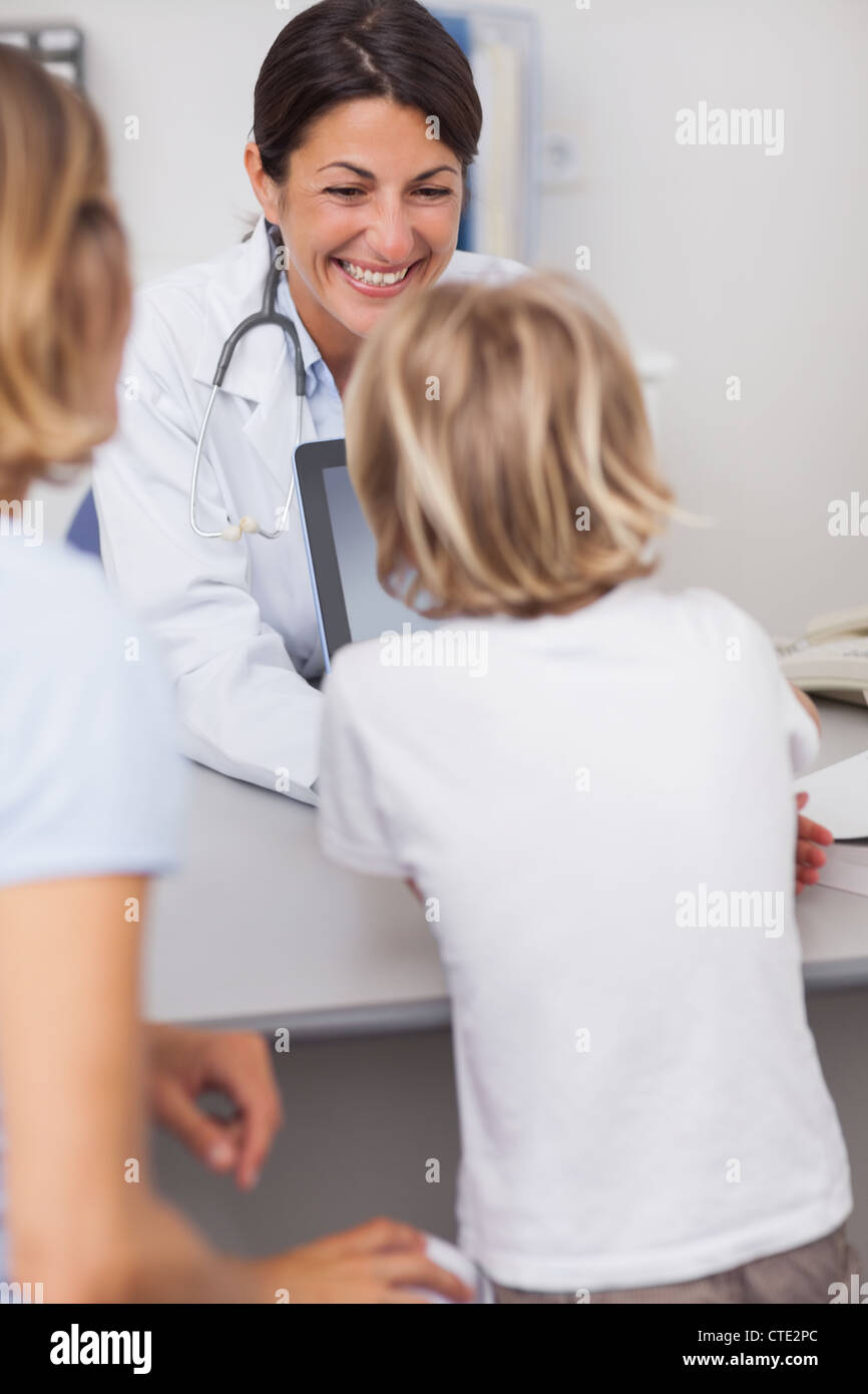Smiling doctor presenting a tablet computer to a child Stock Photo - Alamy