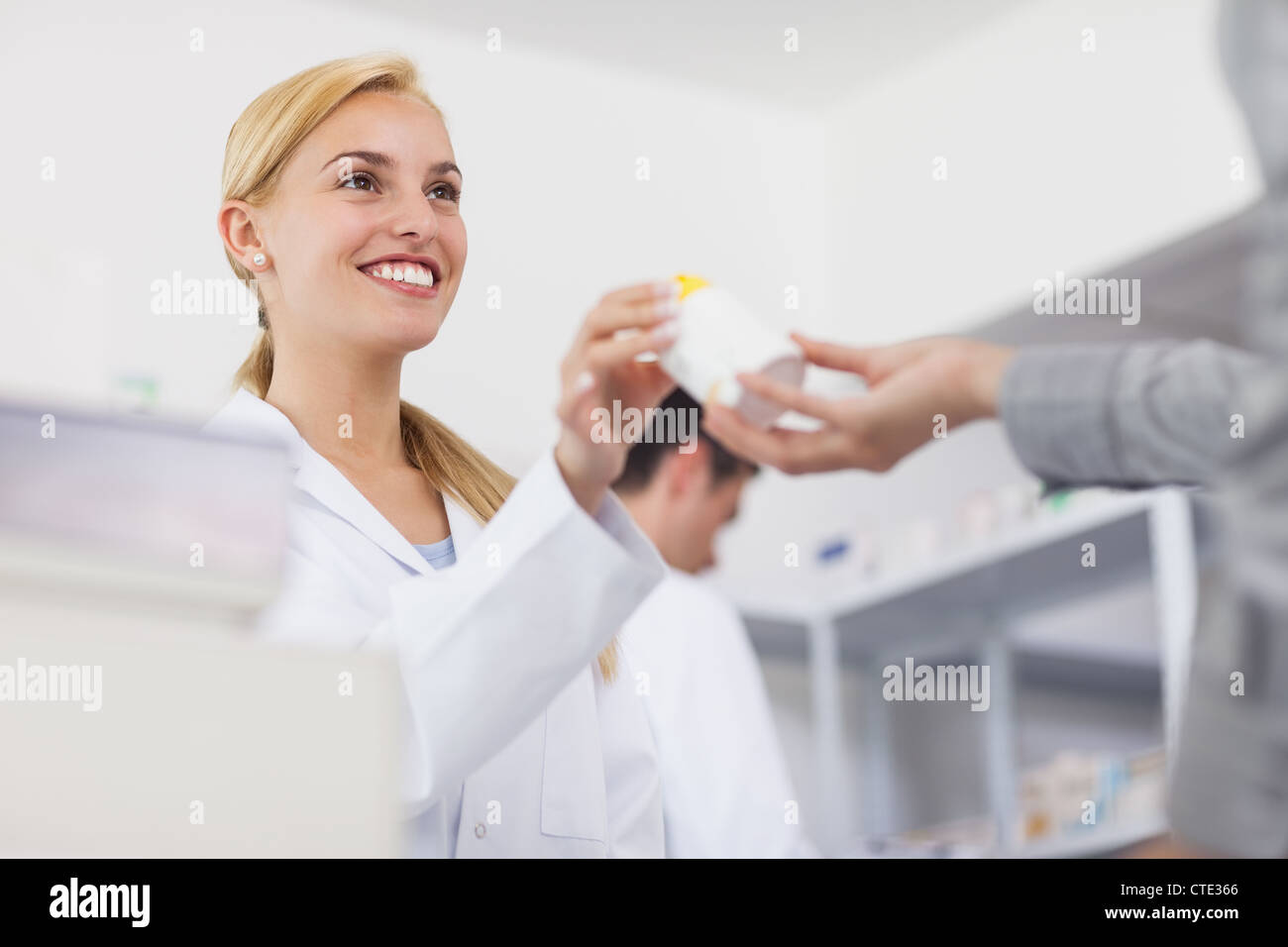 Pharmacist giving a drug box to a patient Stock Photo - Alamy