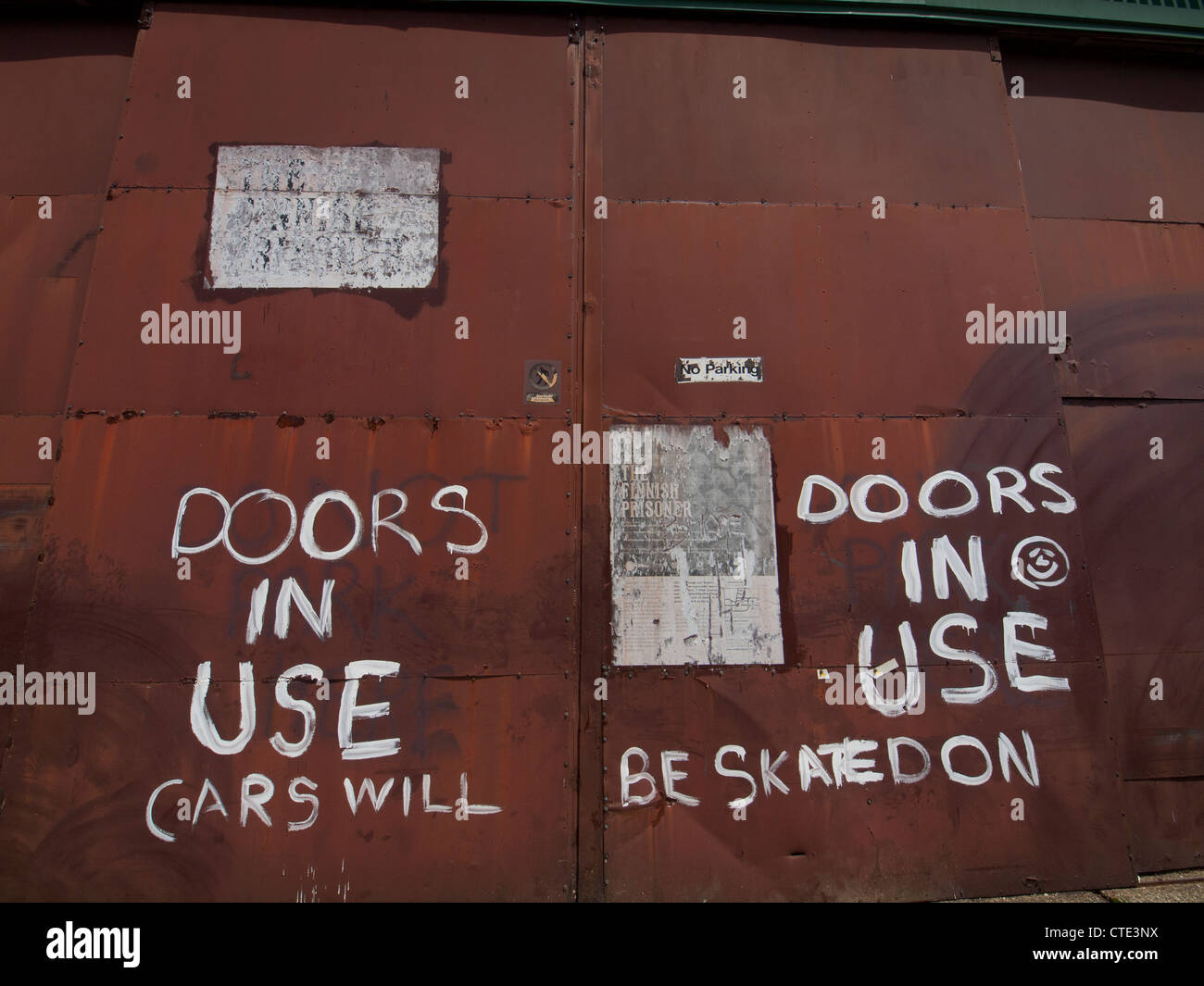 A message on some garage doors Stock Photo - Alamy