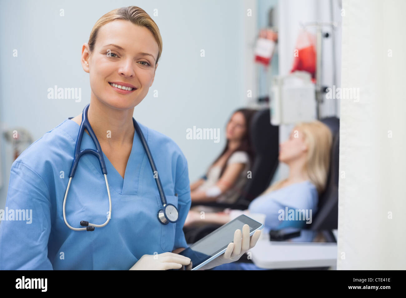 Nurse using a tablet computer Stock Photo - Alamy