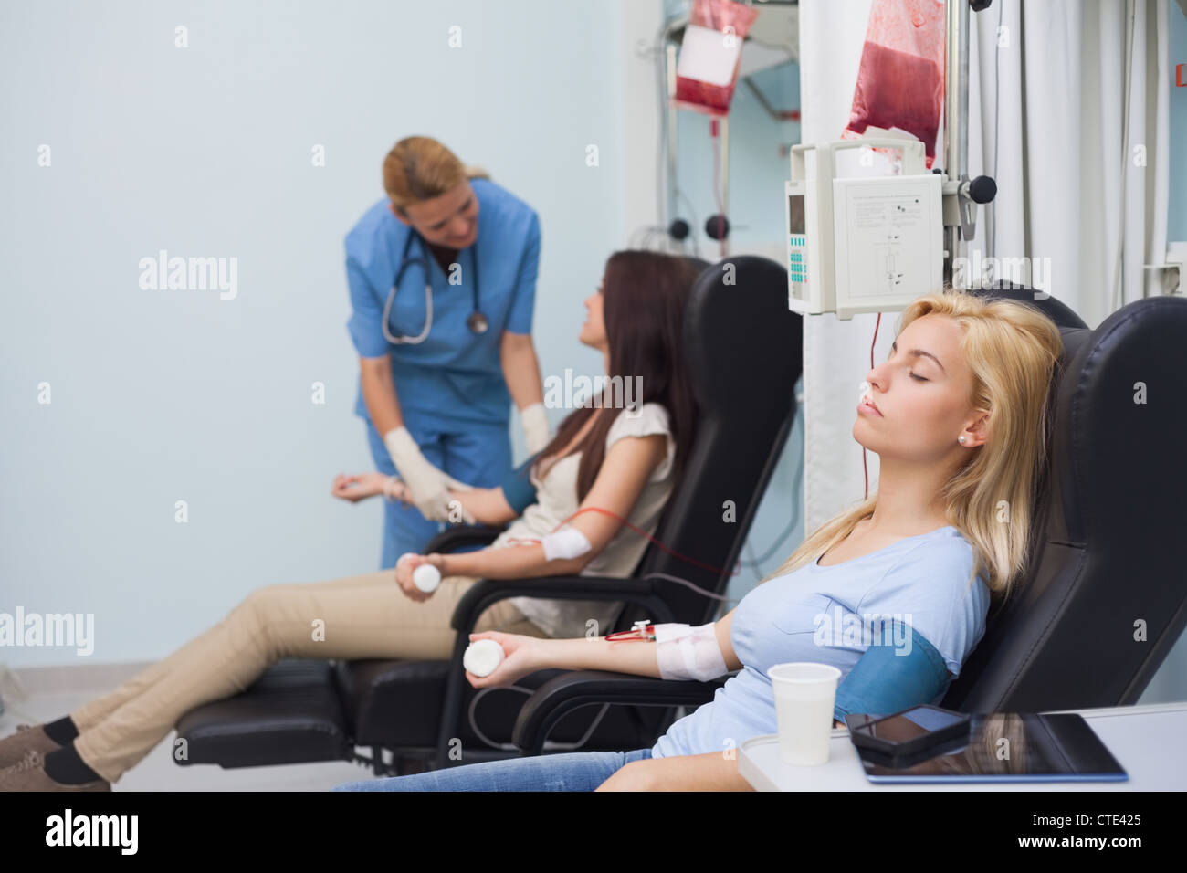 Nurse taking care of a blood donor Stock Photo - Alamy