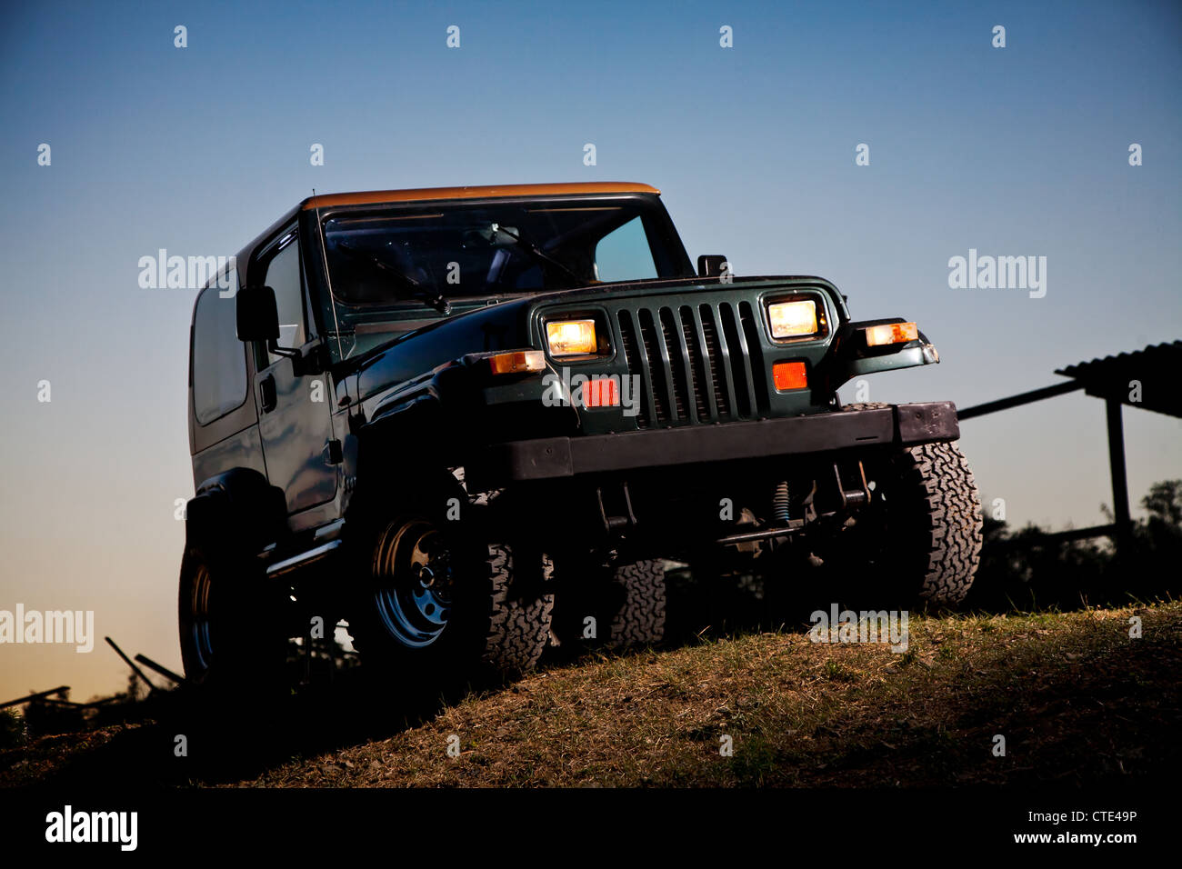 Off road vehicle at hillside on sunset Stock Photo - Alamy