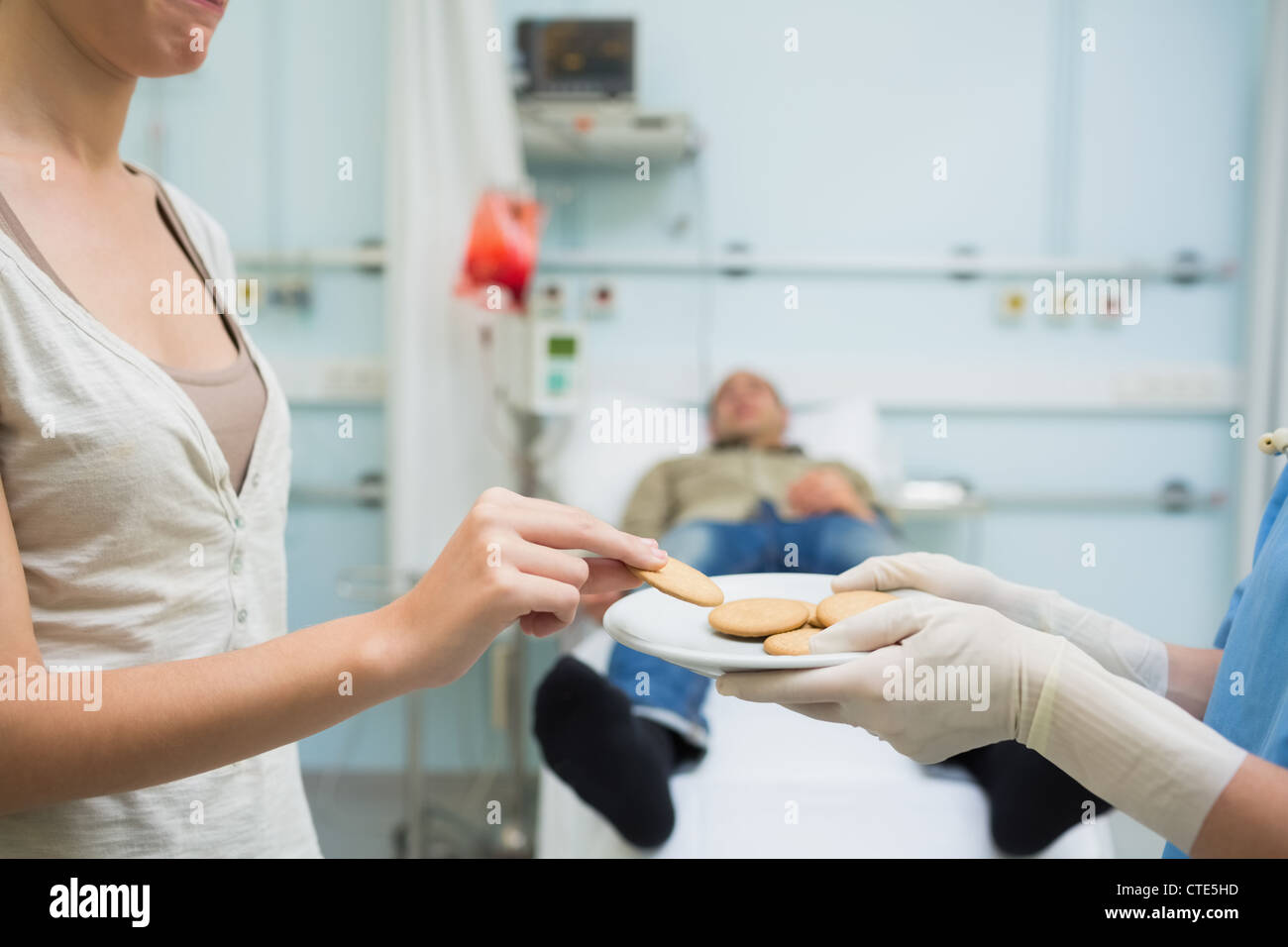 Nurse giving biscuits to a donor Stock Photo - Alamy