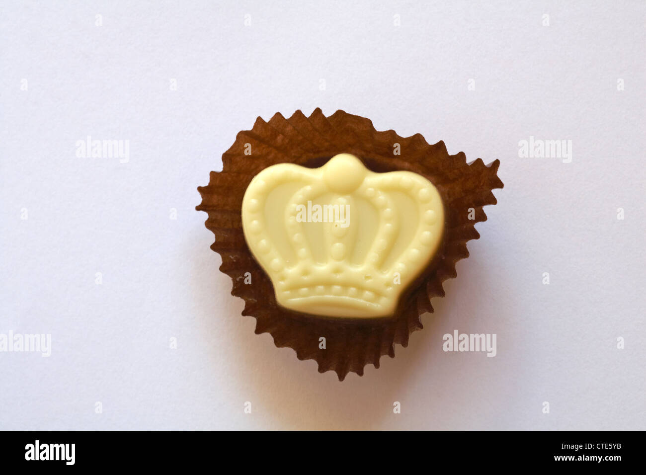 luxury white chocolate in shape of crown in paper case isolated on ...