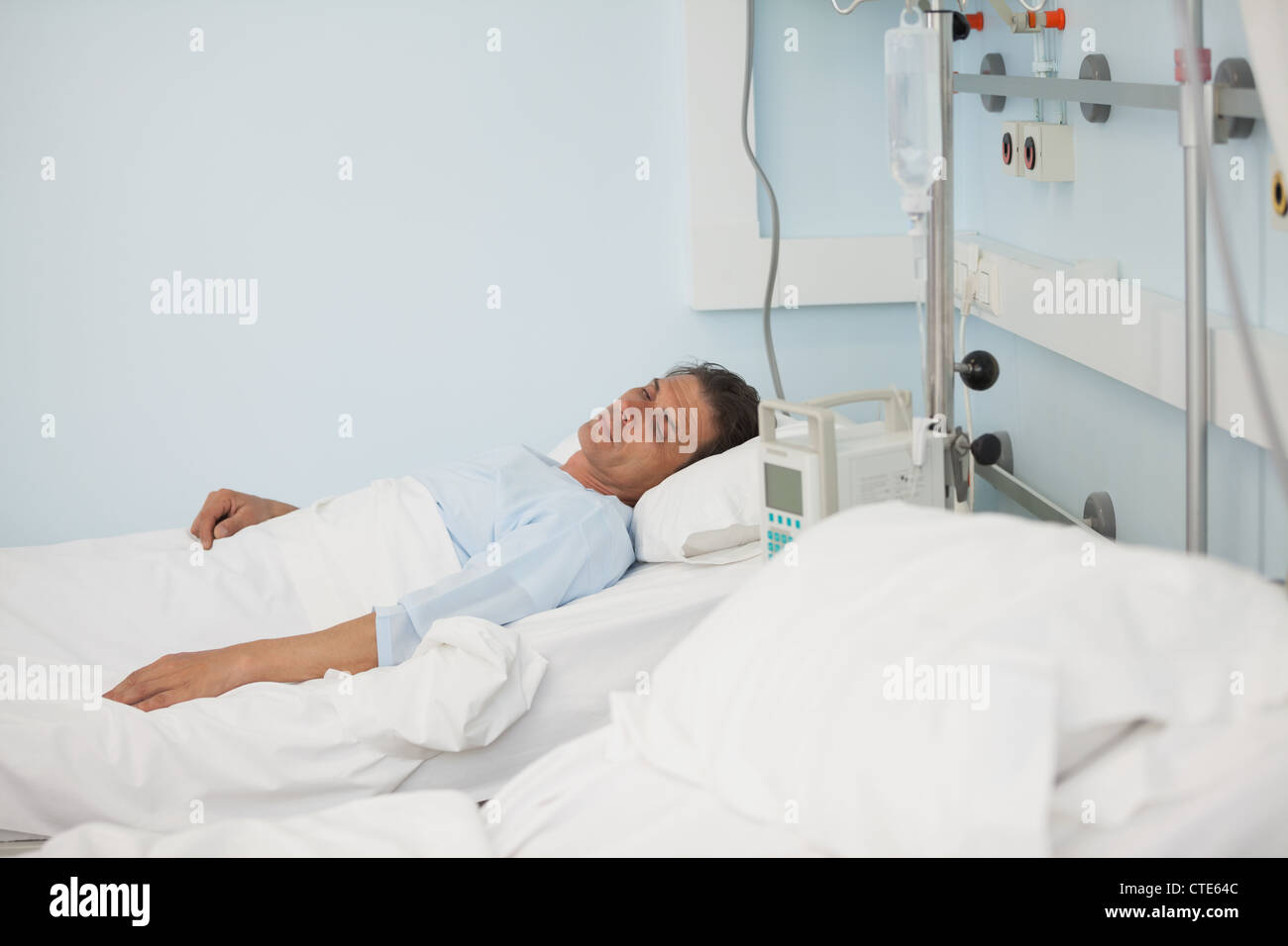 Male patient lying on a medical bed Stock Photo - Alamy
