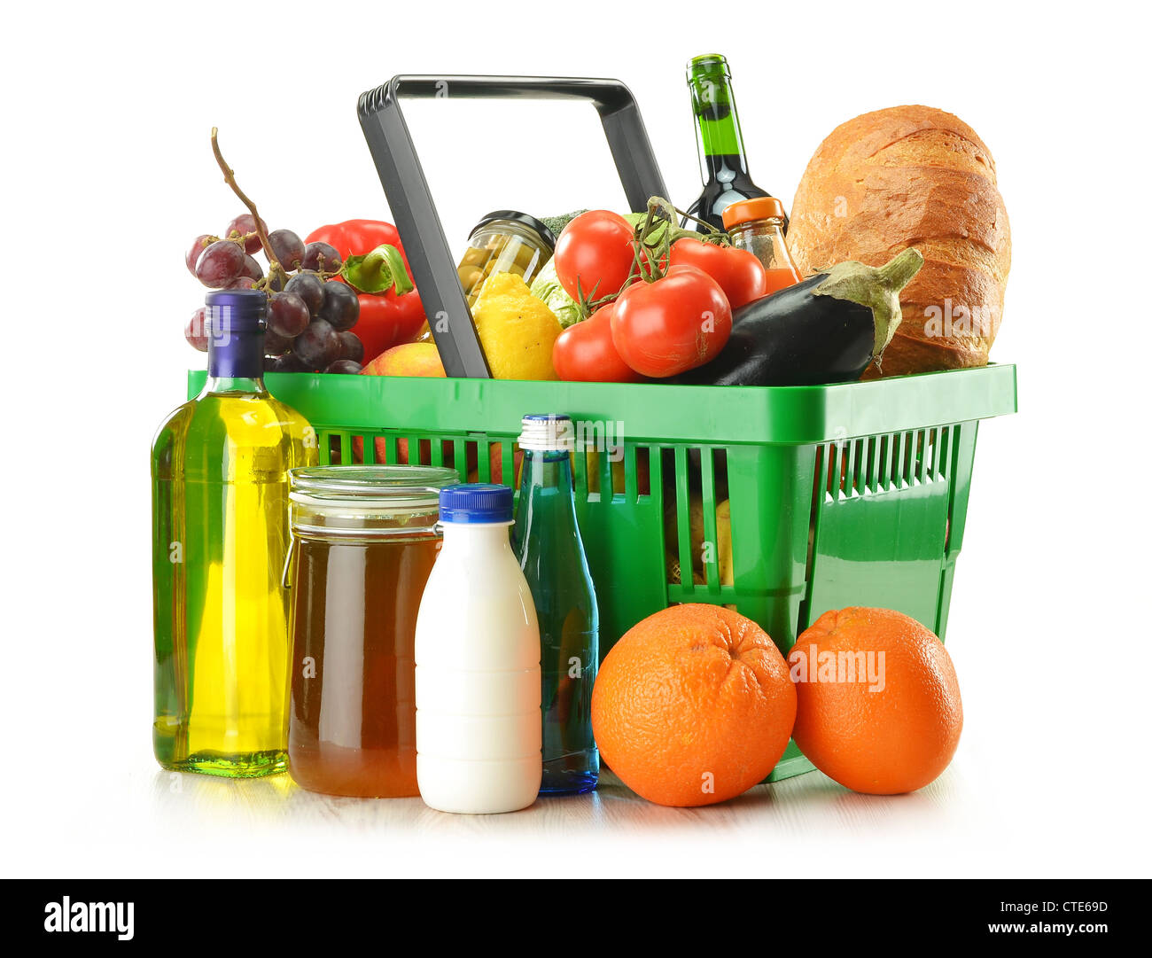 Green shopping basket with variety of grocery products including ...