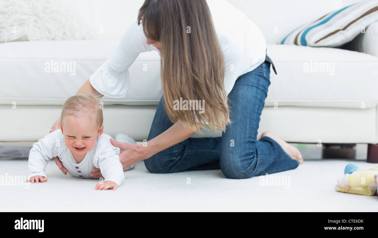 Mother catching a baby Stock Photo - Alamy