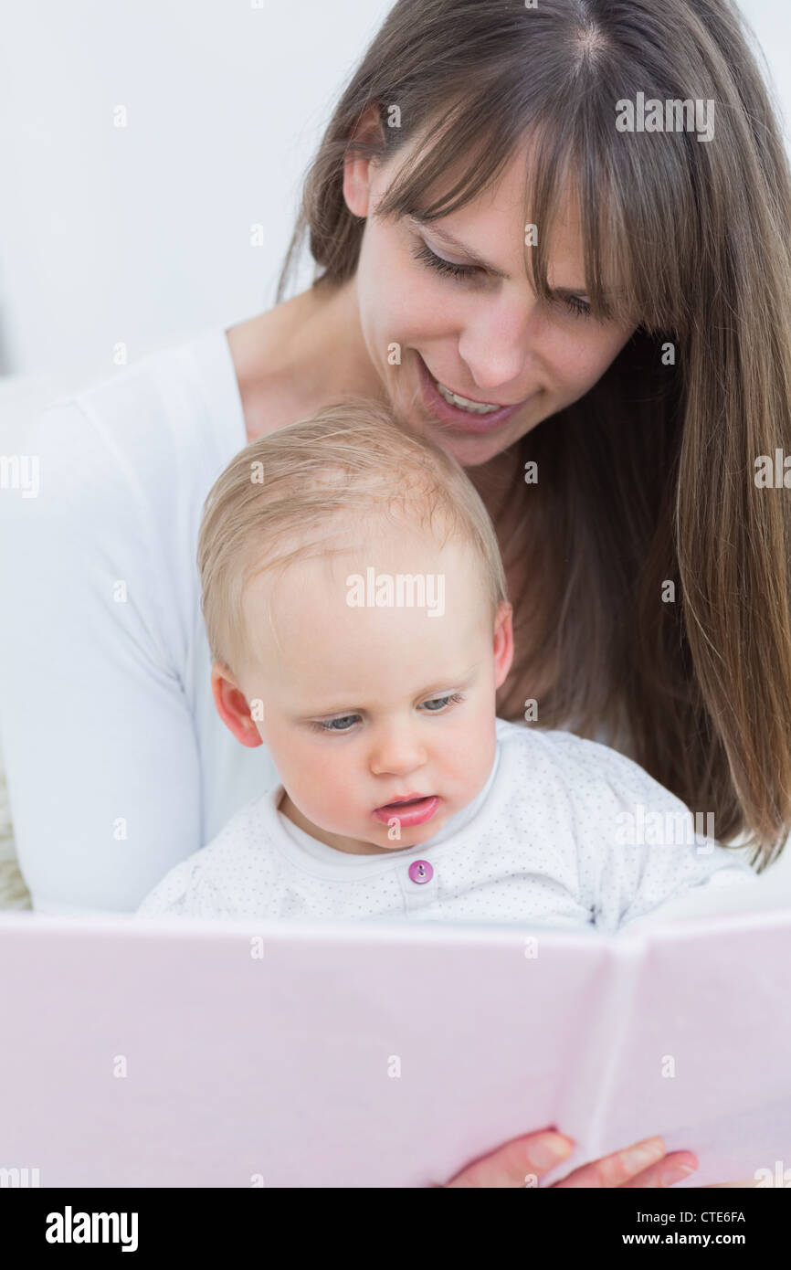 Mother reading a book to a baby Stock Photo - Alamy