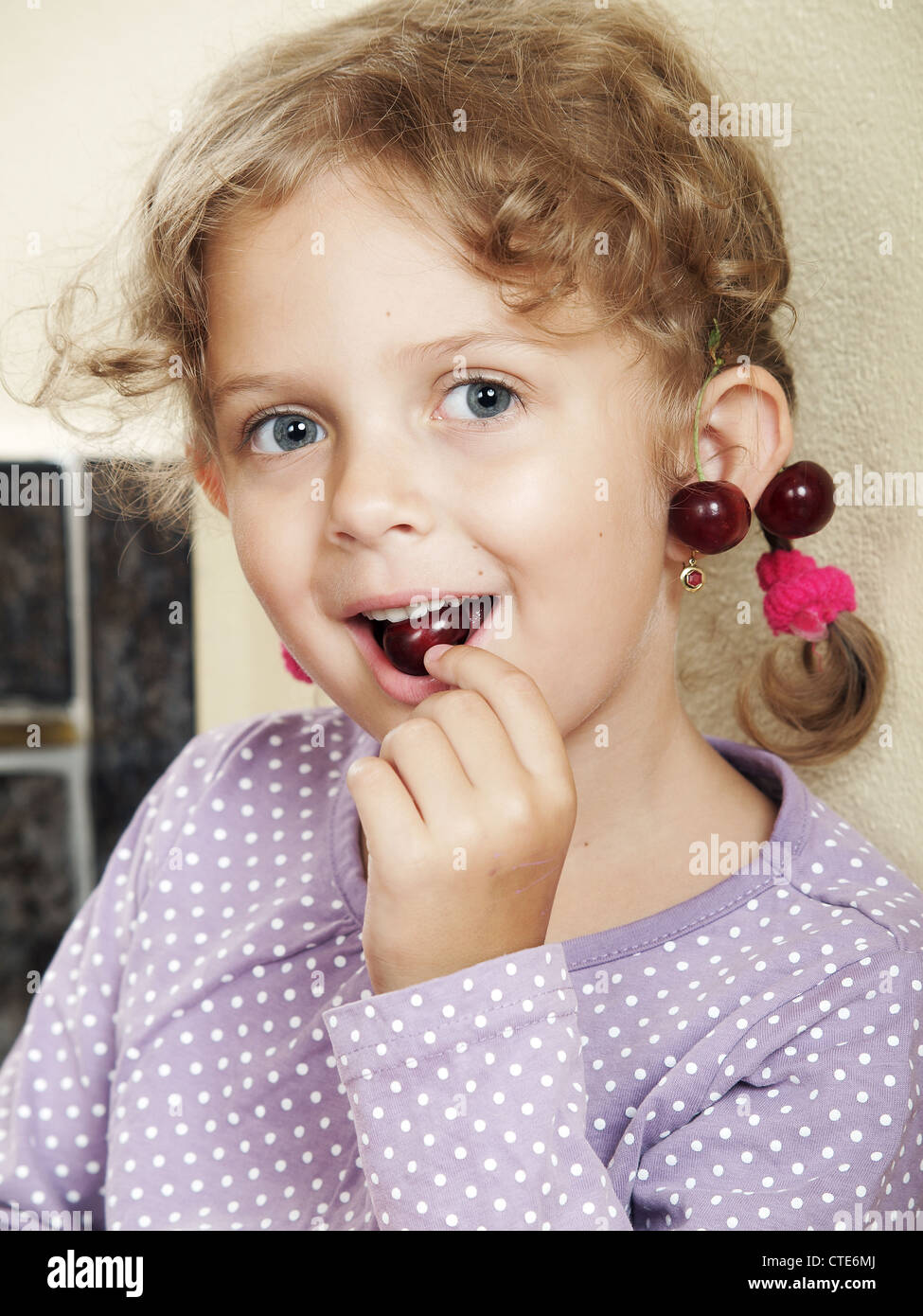 Little girl with cherry Stock Photo - Alamy