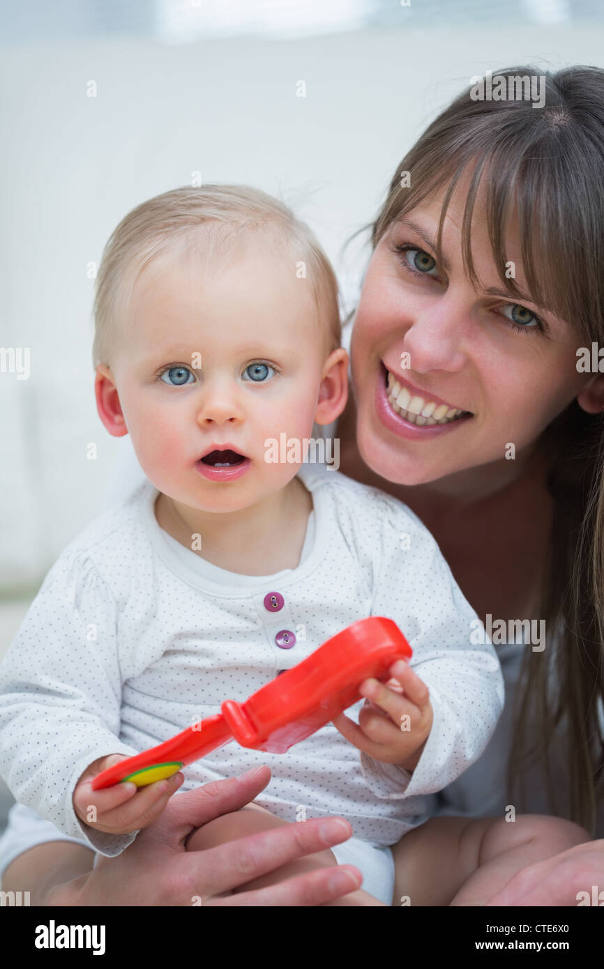 Baby holding a toy Stock Photo - Alamy