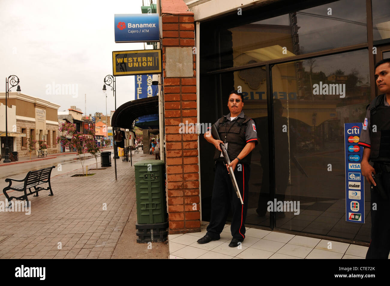 Security guards guard a bank along Calle Obregon in Nogales, Sonora ...