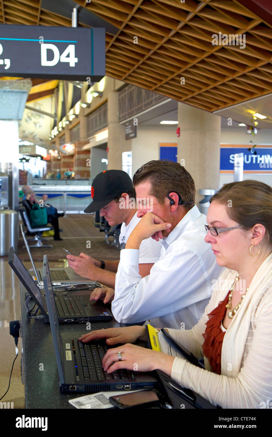 People use wi-fi internet at the Phoenix Sky Harbor International ...