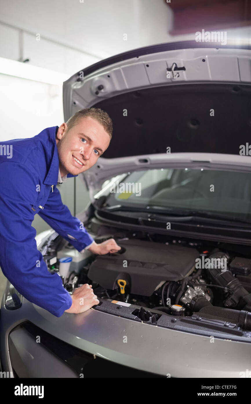 Mechanic looking at camera Stock Photo - Alamy