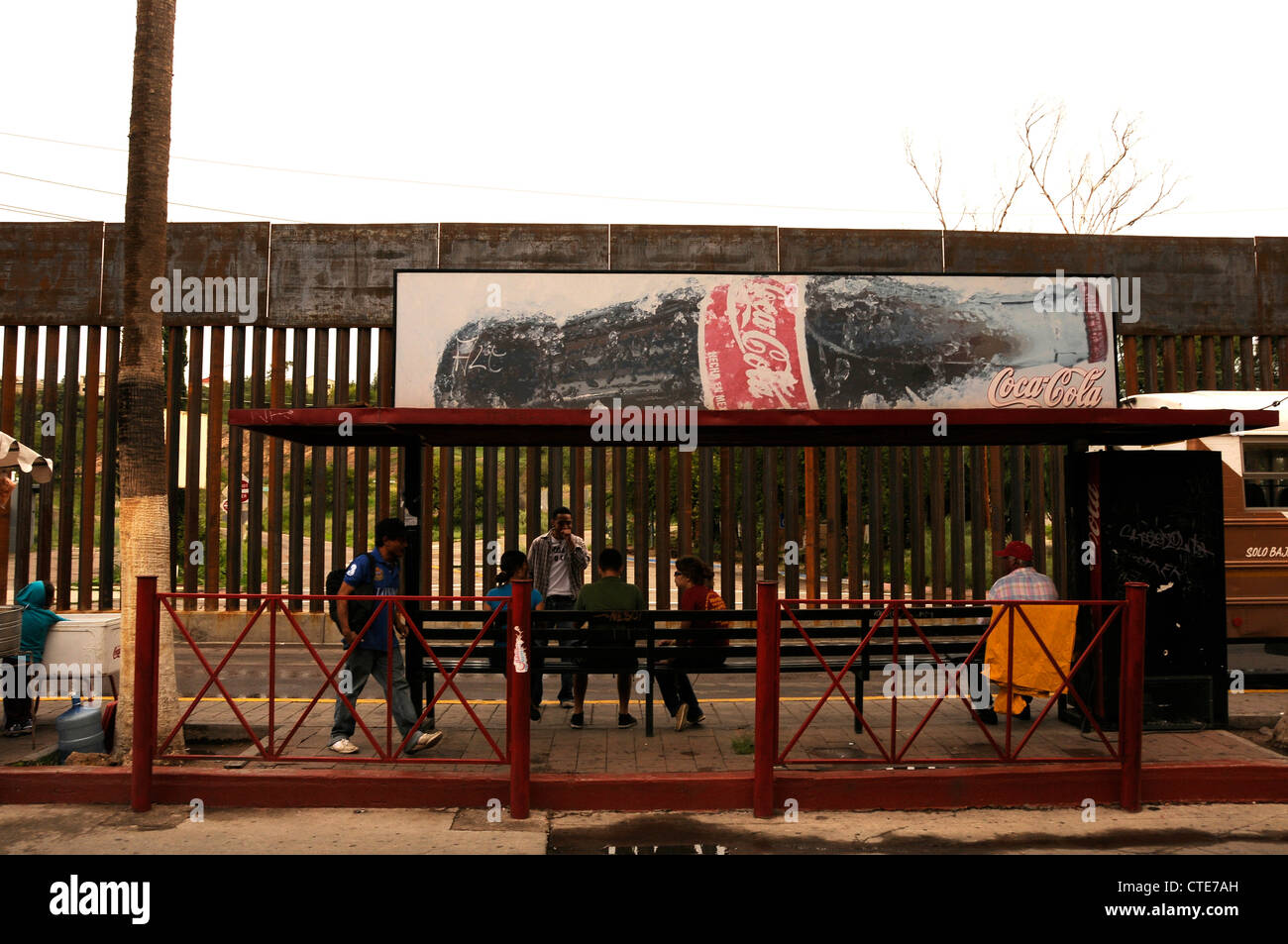 Locals walk near the border wall in Nogales, Sonora, Mexico, located ...